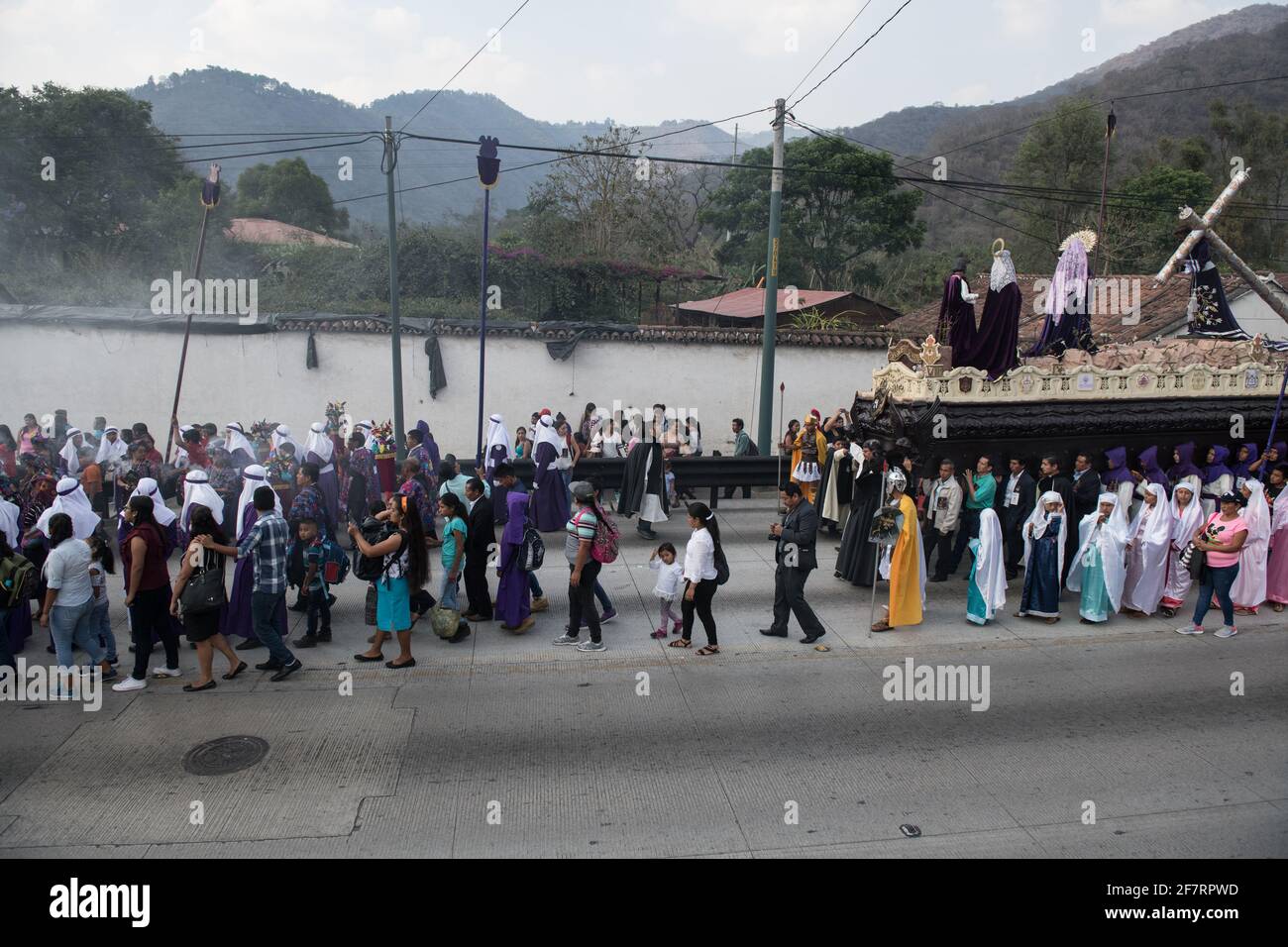 Well-dressed men in suits and women in traditional attire participate ...