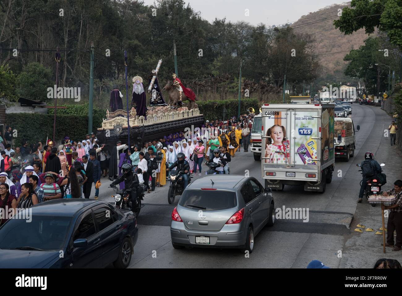 Well-dressed men in suits and women in traditional attire participate ...