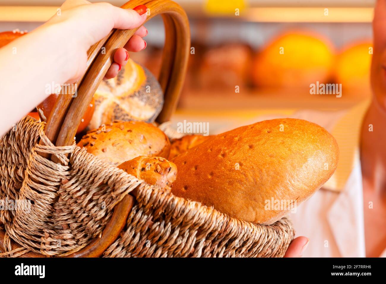 Female baker or saleswoman in her bakery with a female customer and ...