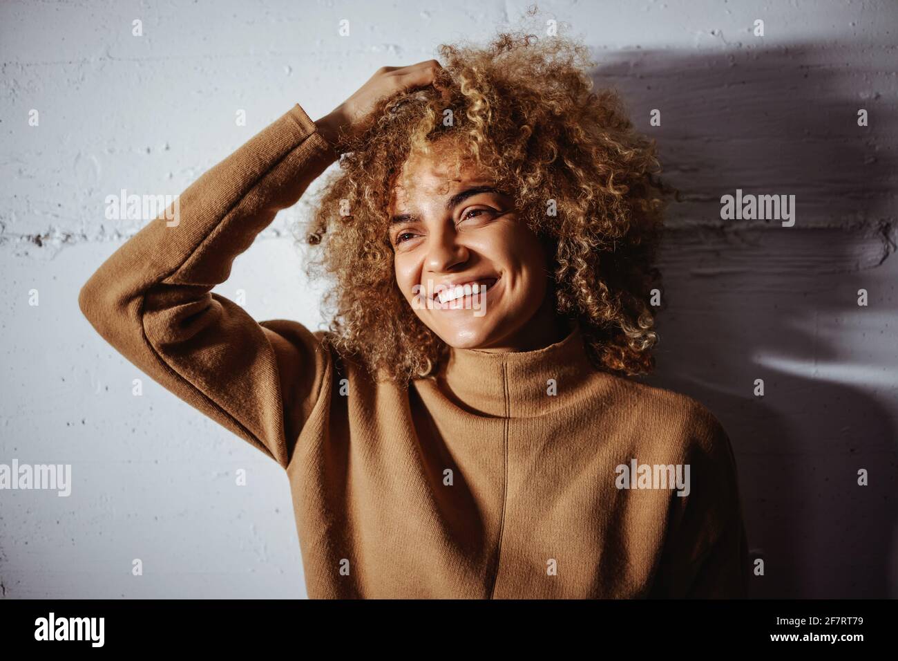 Portrait of smiling mixed race trap girl. Girl is standing against the ...