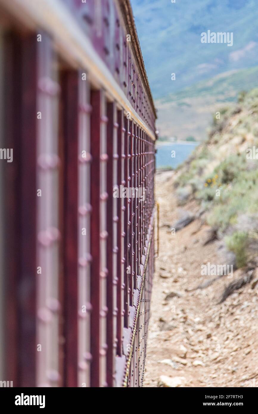 Side view of red train car with blurred background Stock Photo - Alamy