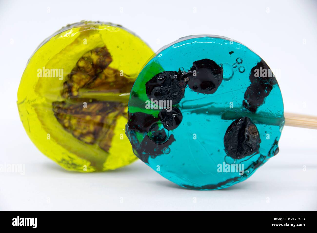 Lollipop with black currant inside turquoise color and lollipop with ...