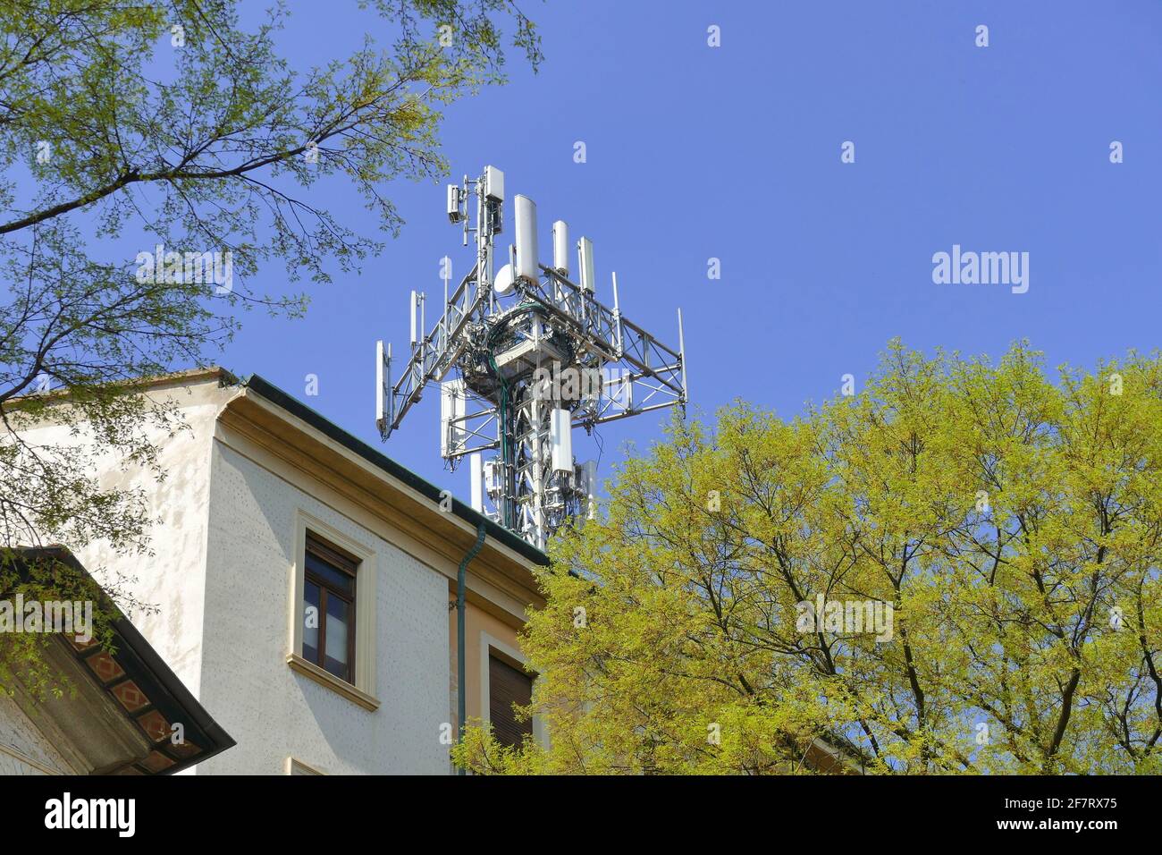 New 5G communication tower on residential building in urban scenery ...