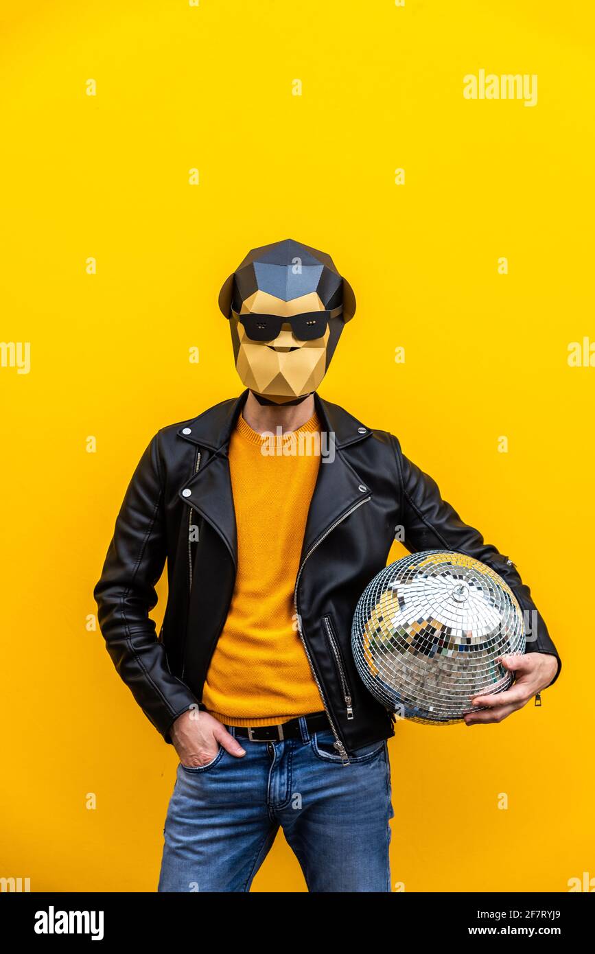 Happy man with funny low poly mask on colored background - Creative ...