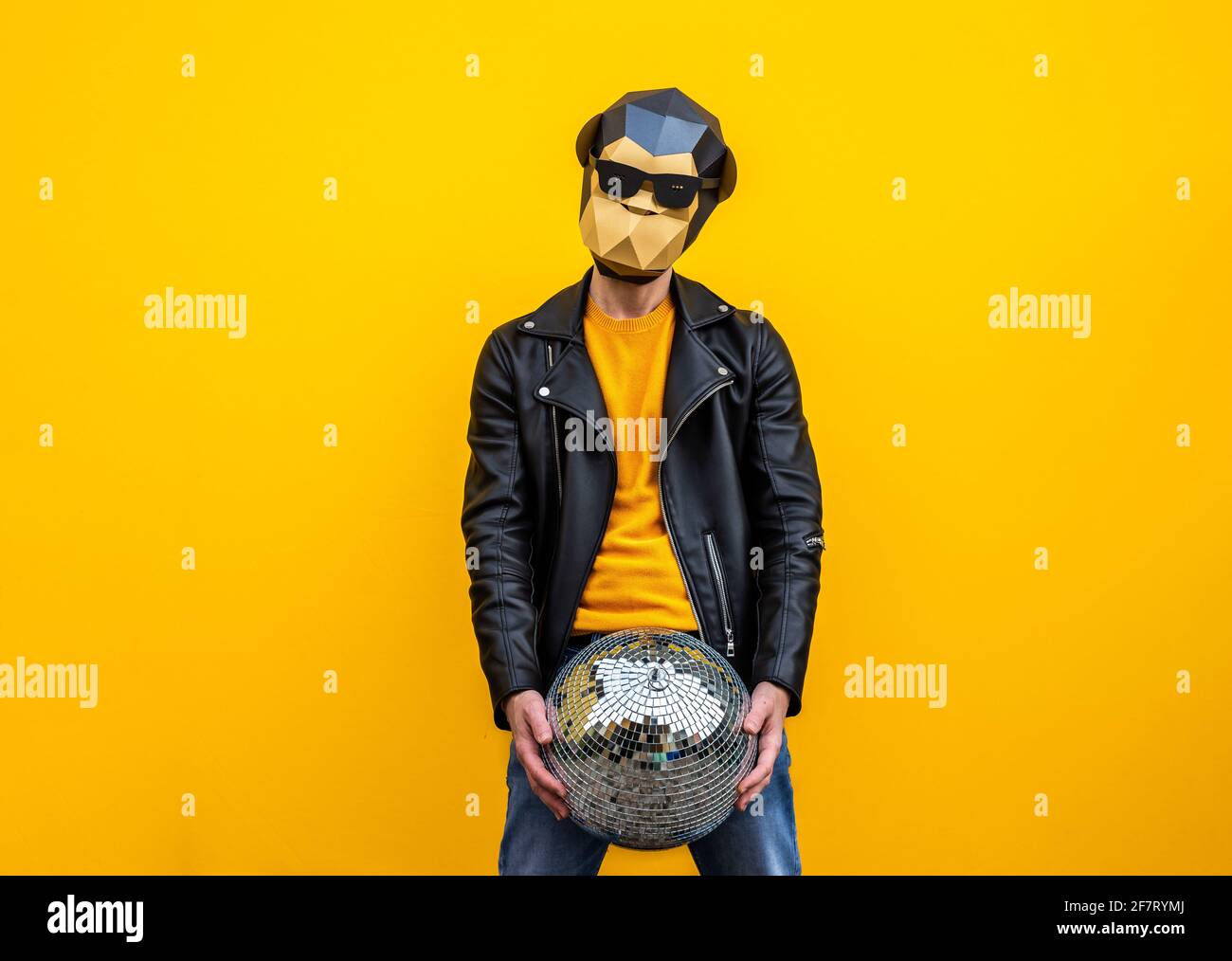 Happy man with funny low poly mask on colored background - Creative ...