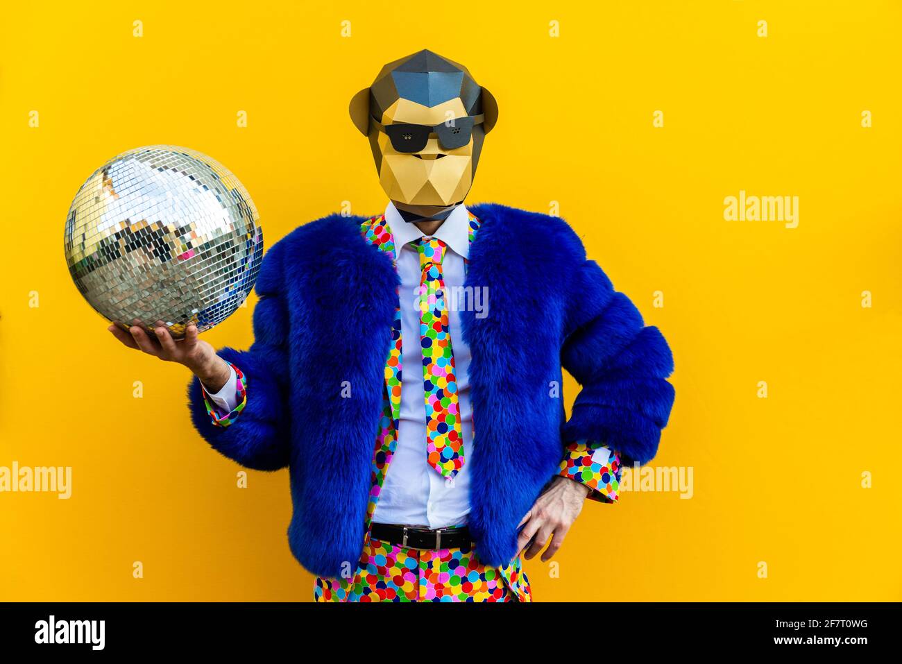 Happy man with funny low poly mask on colored background - Creative ...