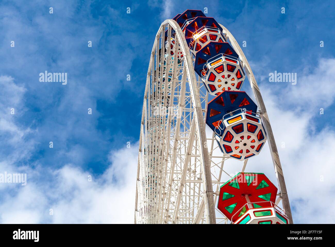 Ferris wheel in an amusement park.Blue sky. Copy space Stock Photo - Alamy