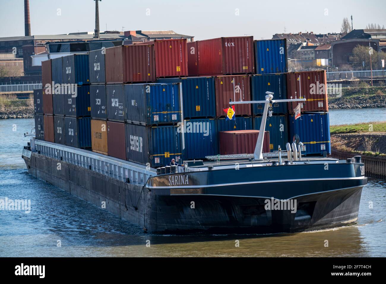 Container cargo ship enters the harbour basin of the Logport, container ...