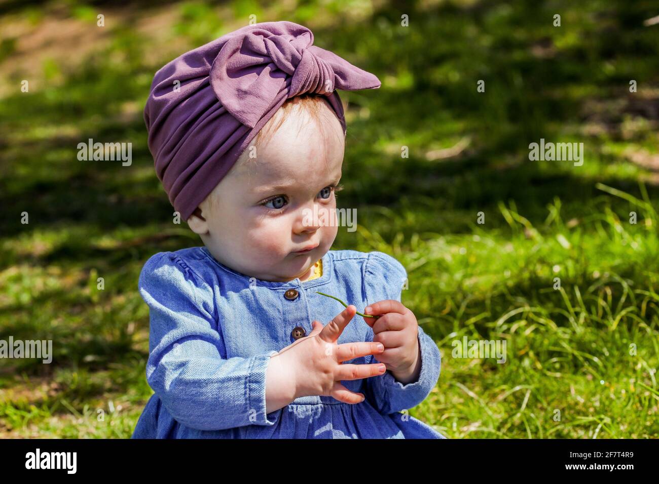 Cute baby girl outdoor in spring time on grass Stock Photo - Alamy