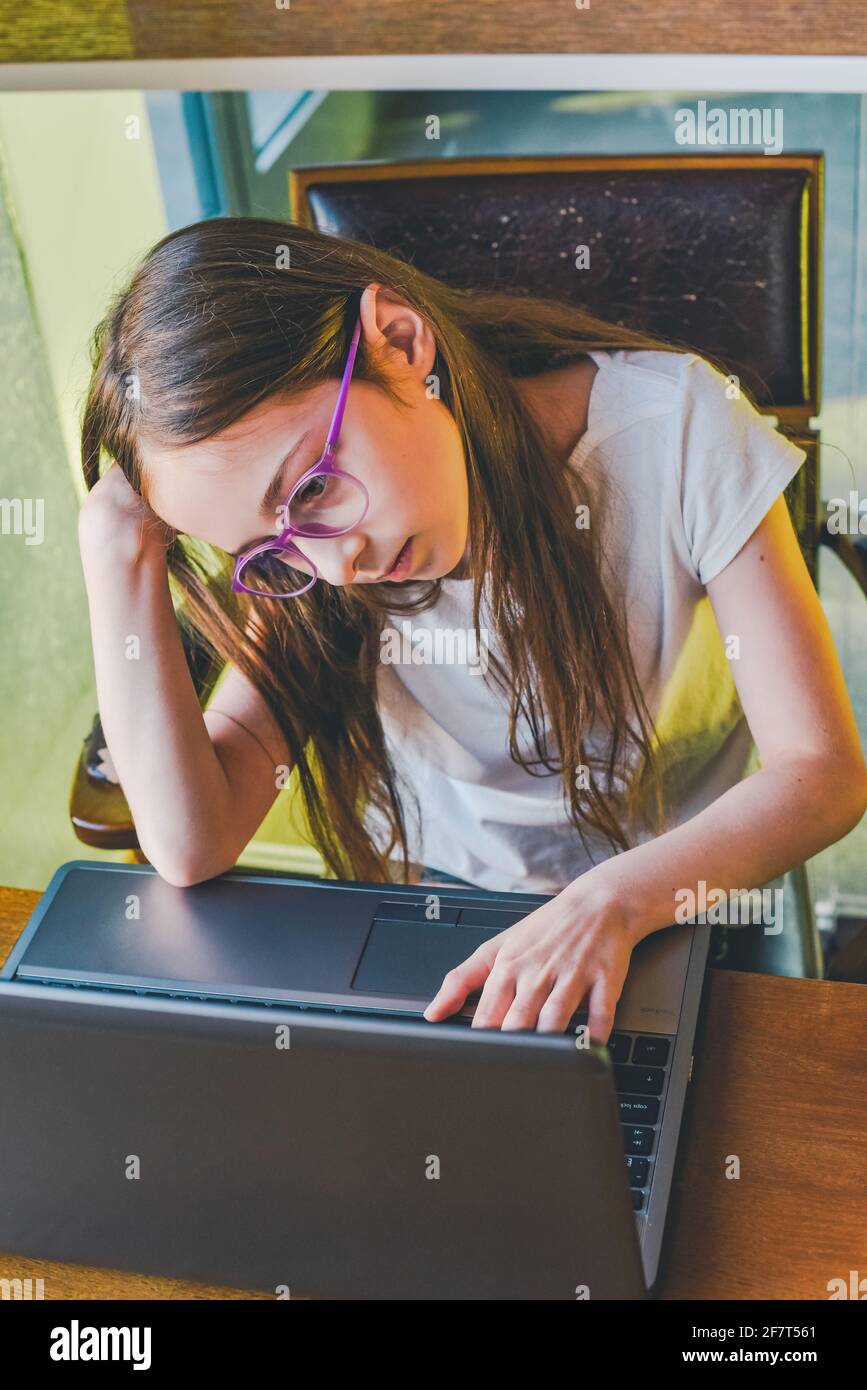 Teenage girl at the computer home teaching. computer, distant learn ...
