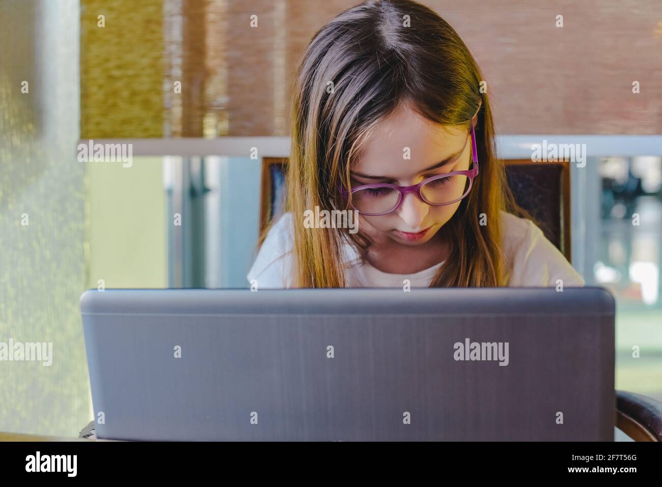 Teenage girl at the computer home teaching. computer, distant learn ...