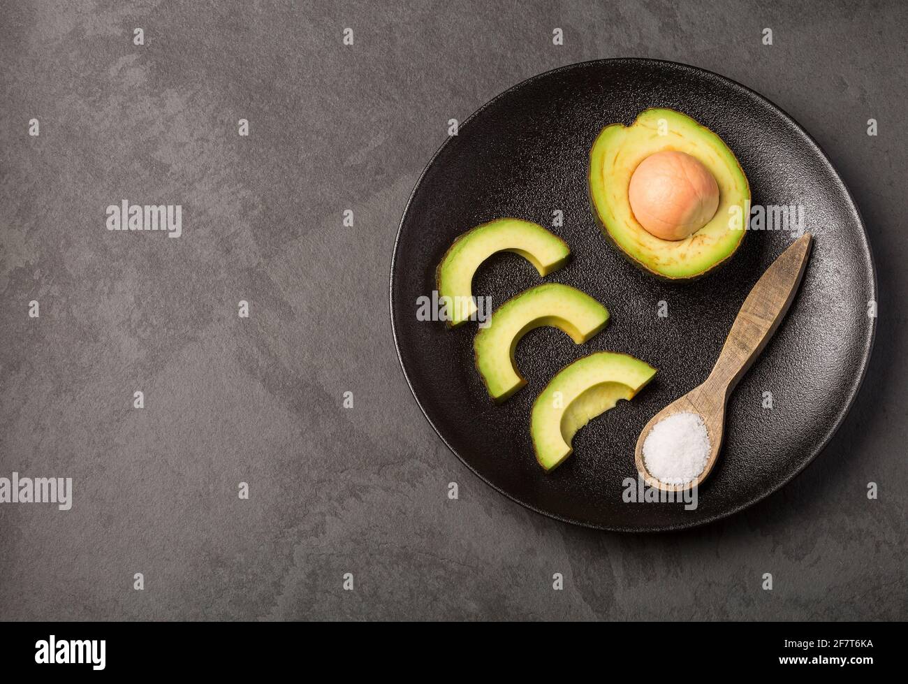 Avocado and salt - Persea americana 'Hass'. Top view Stock Photo - Alamy