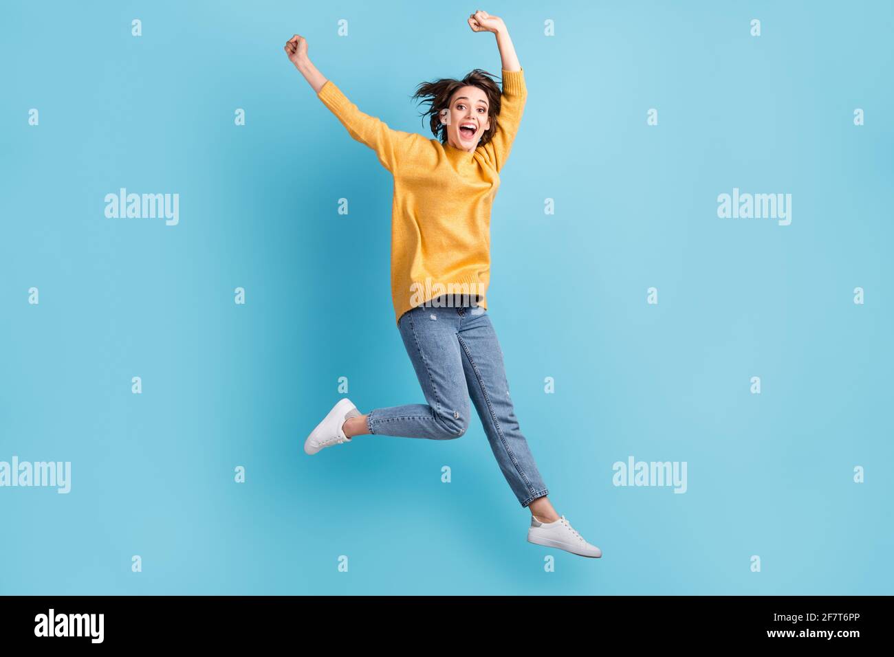 Full length body photo of crazy young girl jumping high hands over head ...