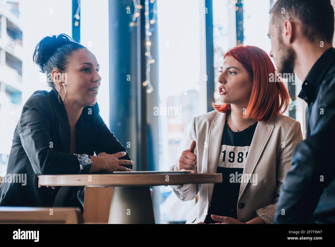 Young attractive people having a pleasant conversation about work at a ...