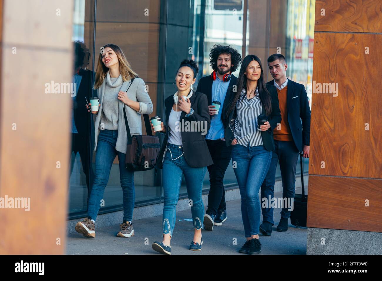 Group of colleagues on a business trip (euro trip) walking together at ...