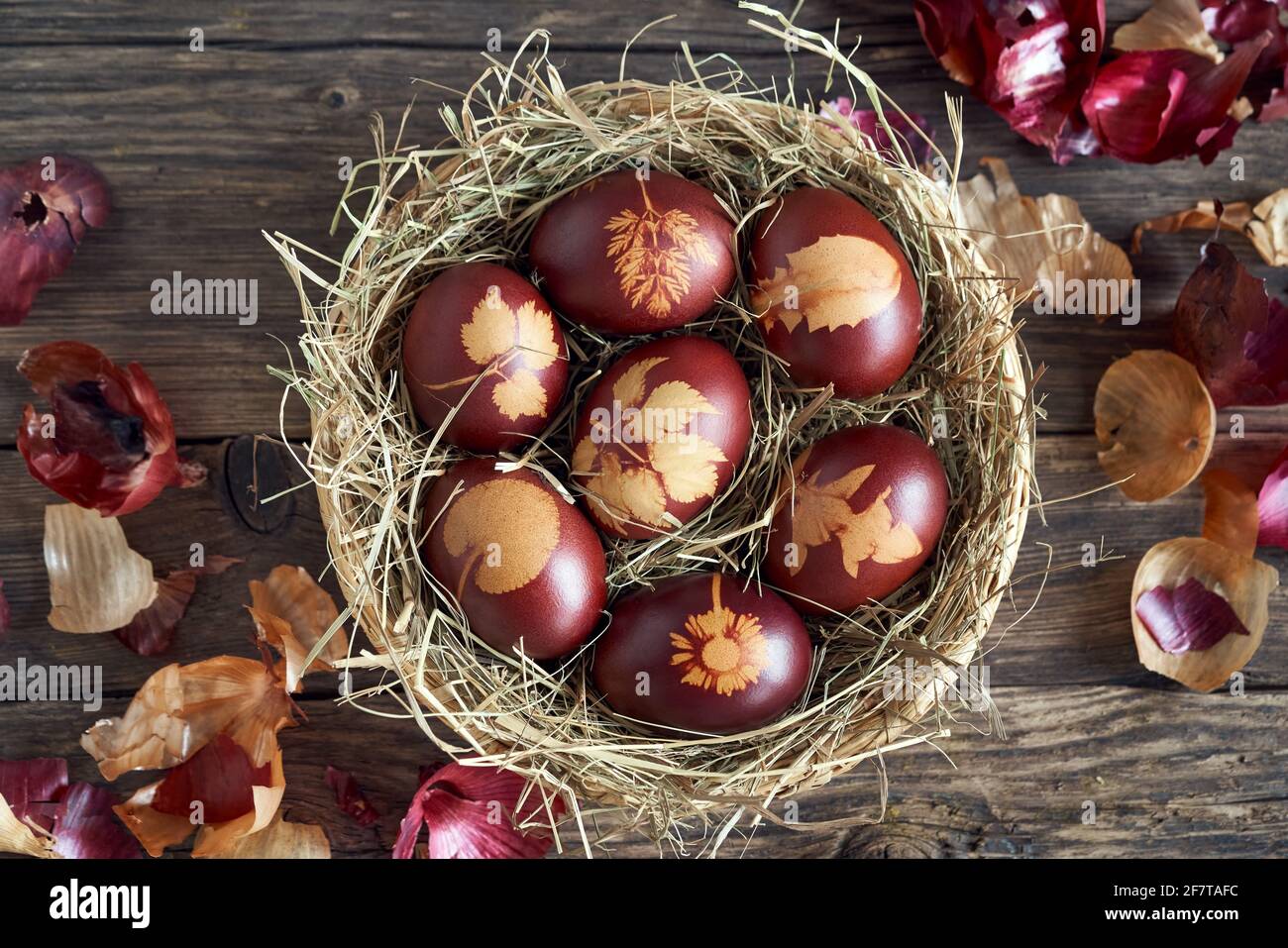 Easter eggs dyed with onion peels with a pattern of fresh leaves in a ...