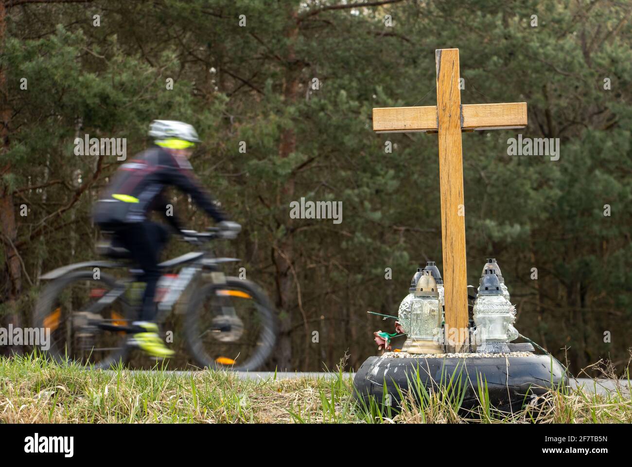 A roadside memorial cross with a candles commemorating the tragic death ...