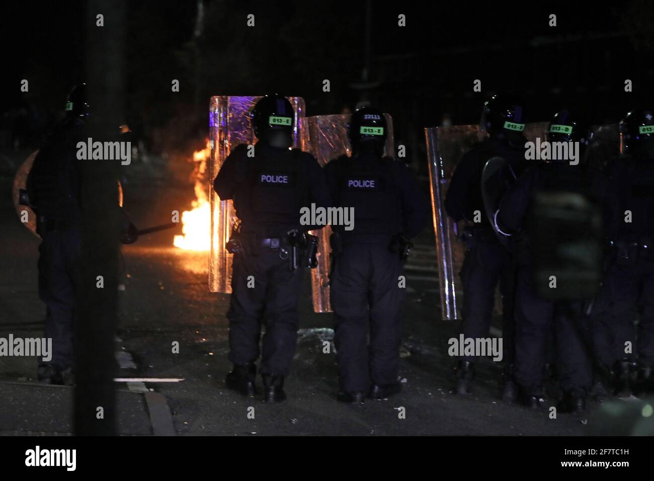 PSNI officers with riot shields line a street in the Tigers Bay area of ...