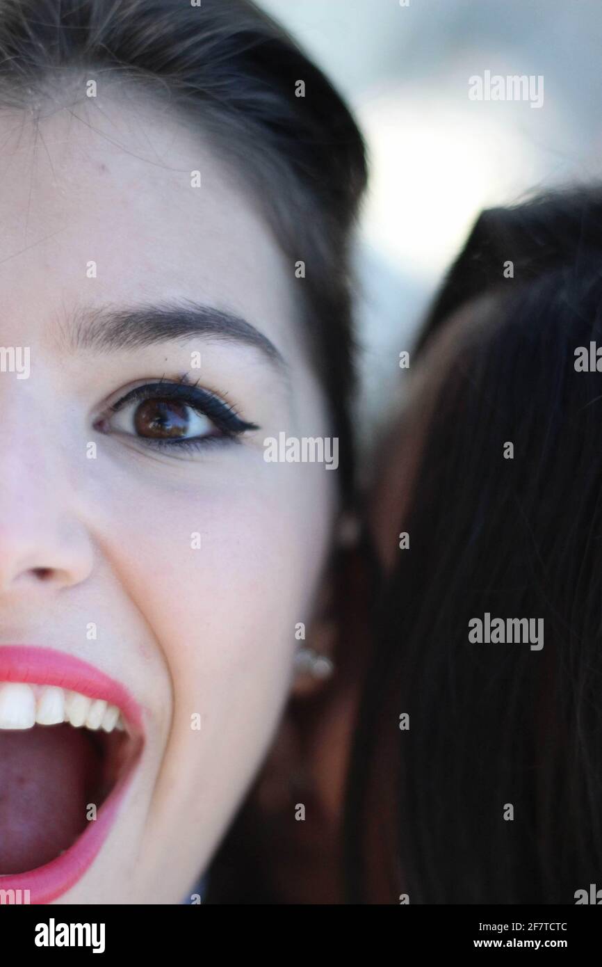 Vertical shot of the face of a young caucasian female with an open ...