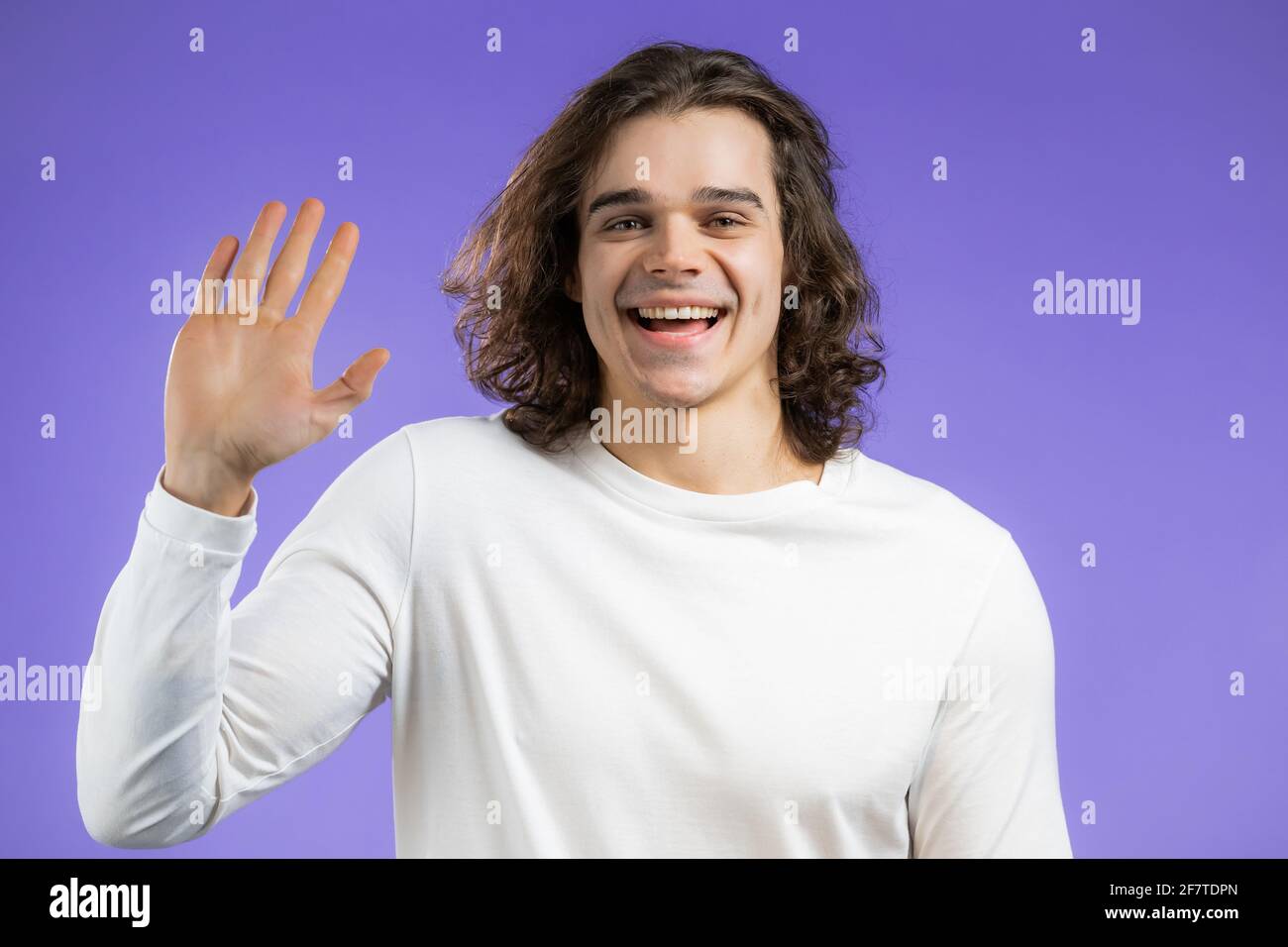 Young friendly man waving hand - hello. Greeting, say Hi to camera. Guy ...