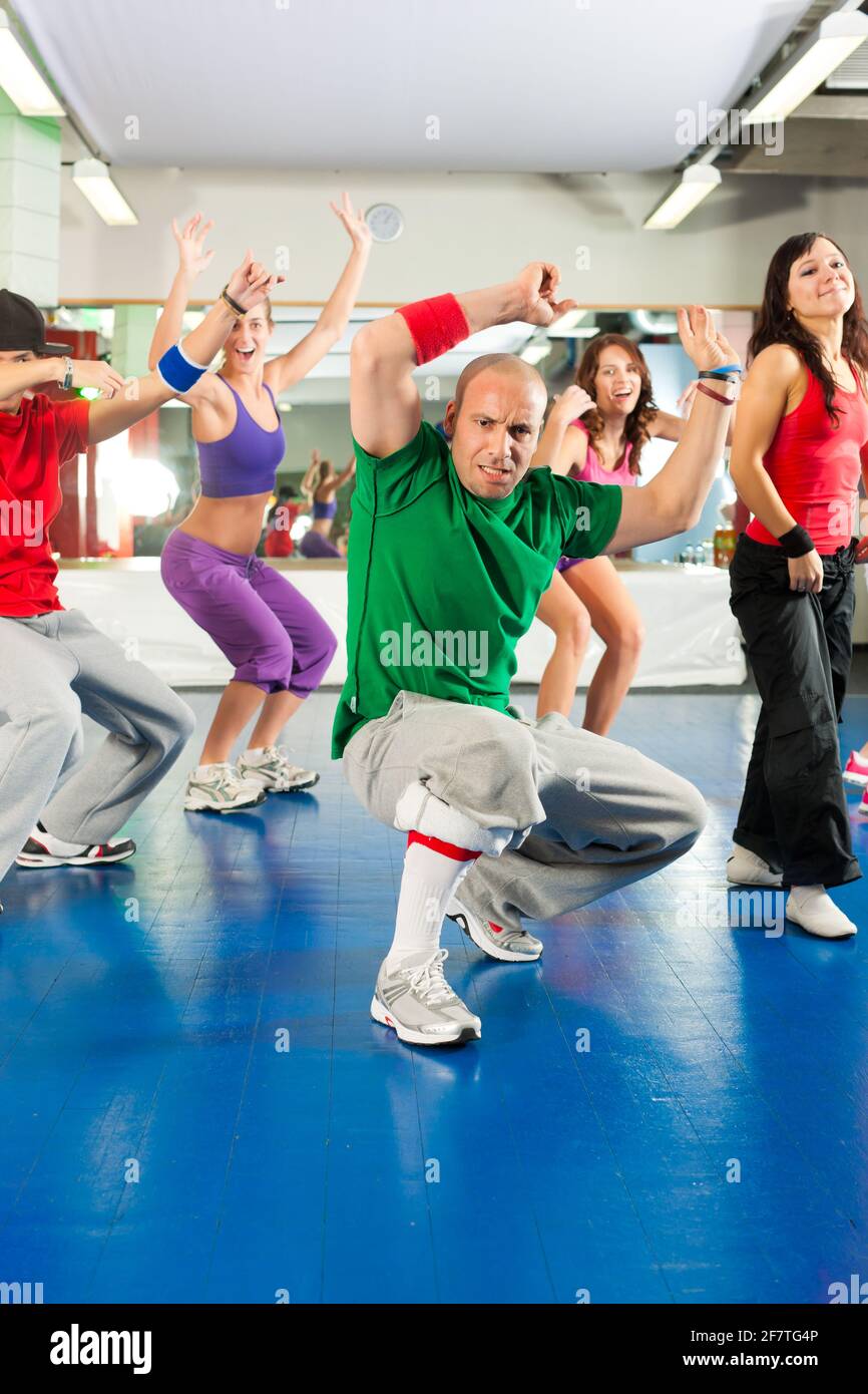 Fitness - Young people doing Zumba training or dance workout in a gym ...