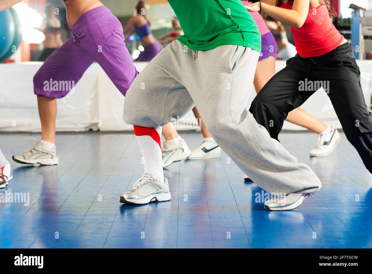 Fitness - Young people (only legs to be seen) doing Zumba training or ...