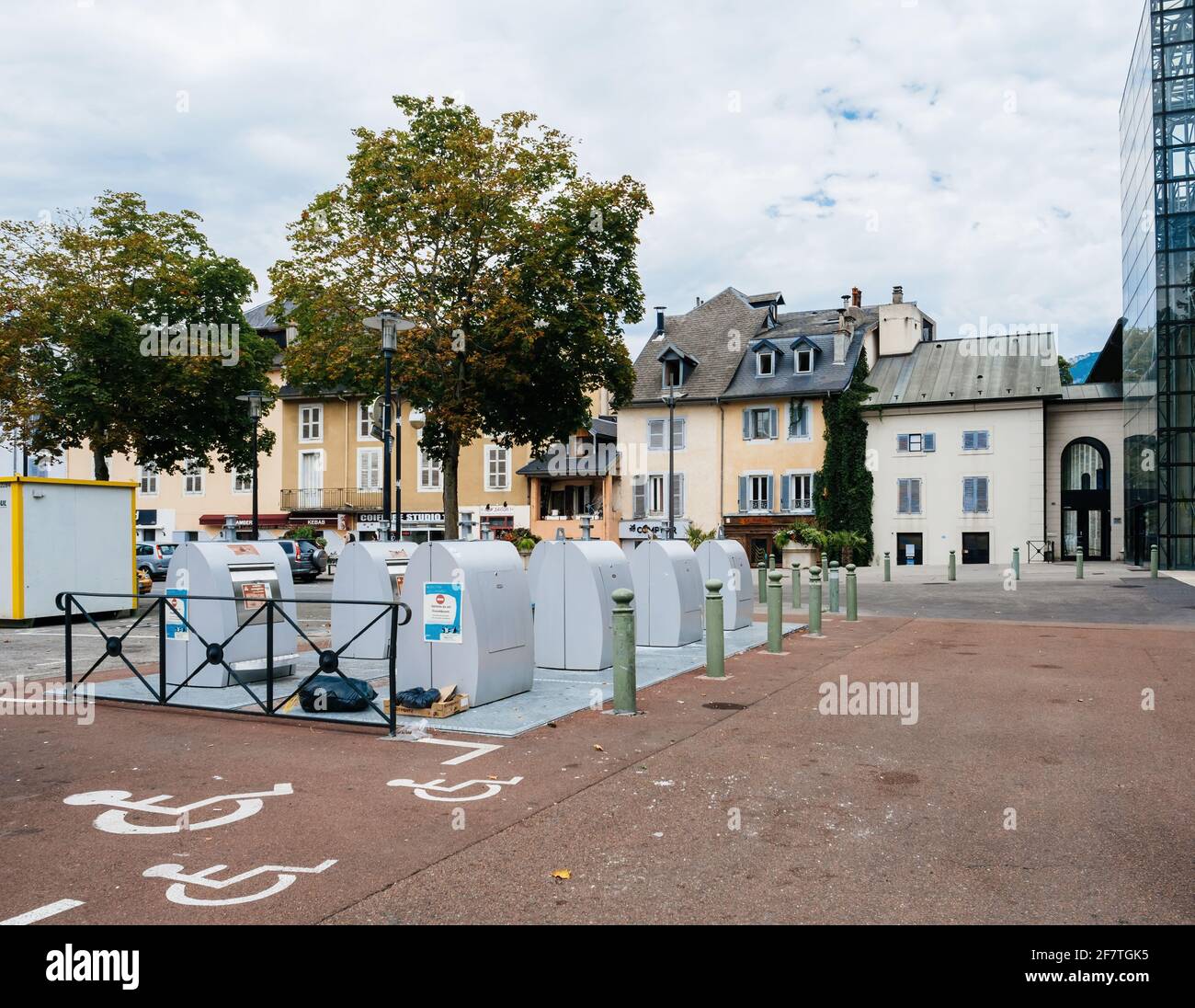 Waste recycling metallic containers in central square near disabled ...