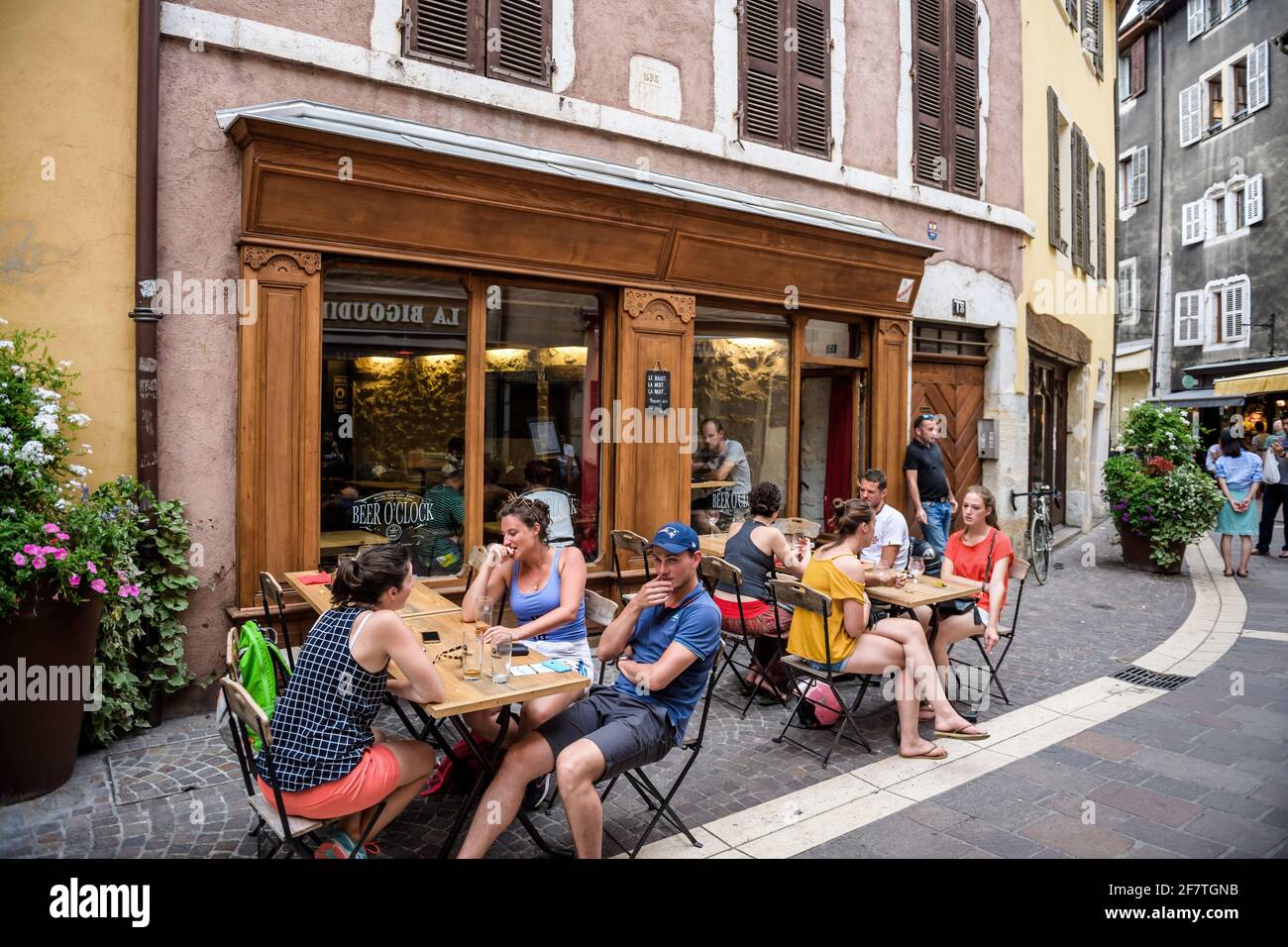 Young customers drinking fresh cold beer outside terrace at Beer o ...