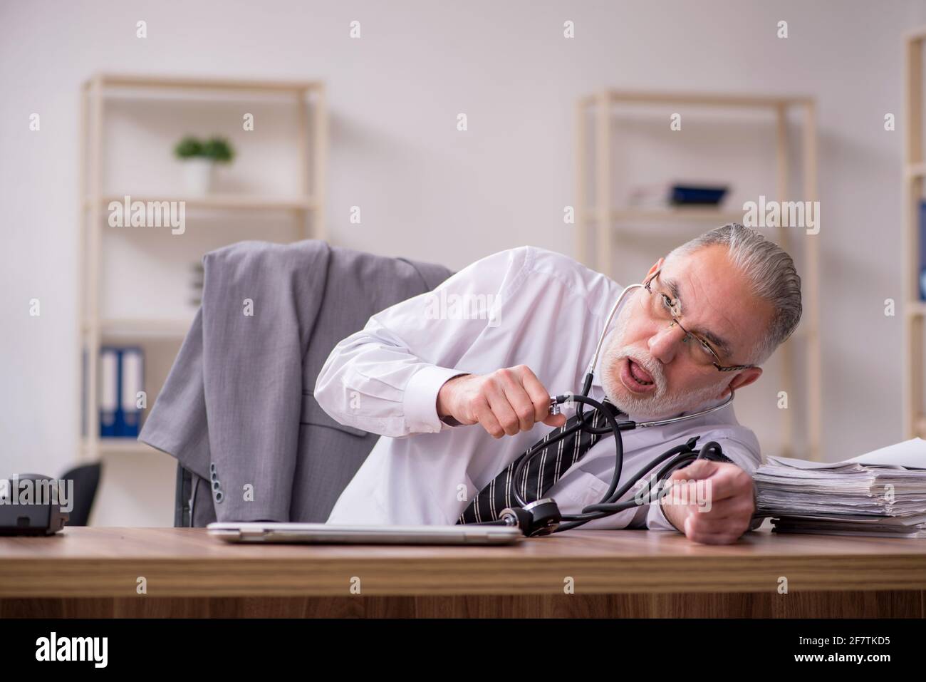 Aged male employee feeling bad in the office Stock Photo - Alamy