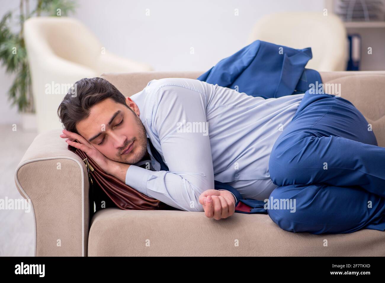 Young male employee waiting for business meeting Stock Photo - Alamy