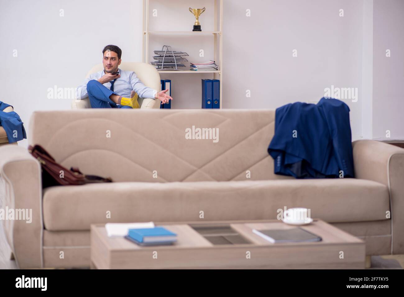 Young male employee waiting for business meeting Stock Photo - Alamy