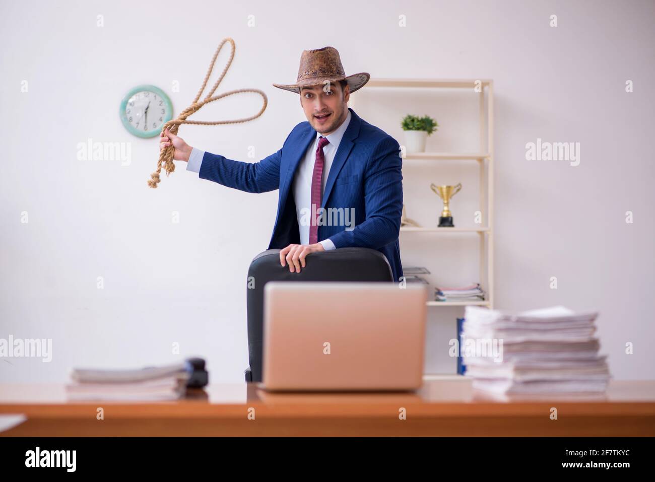 Young cowboy employee working at workplace Stock Photo - Alamy