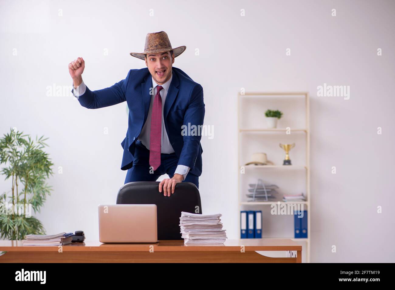 Young cowboy employee working at workplace Stock Photo - Alamy