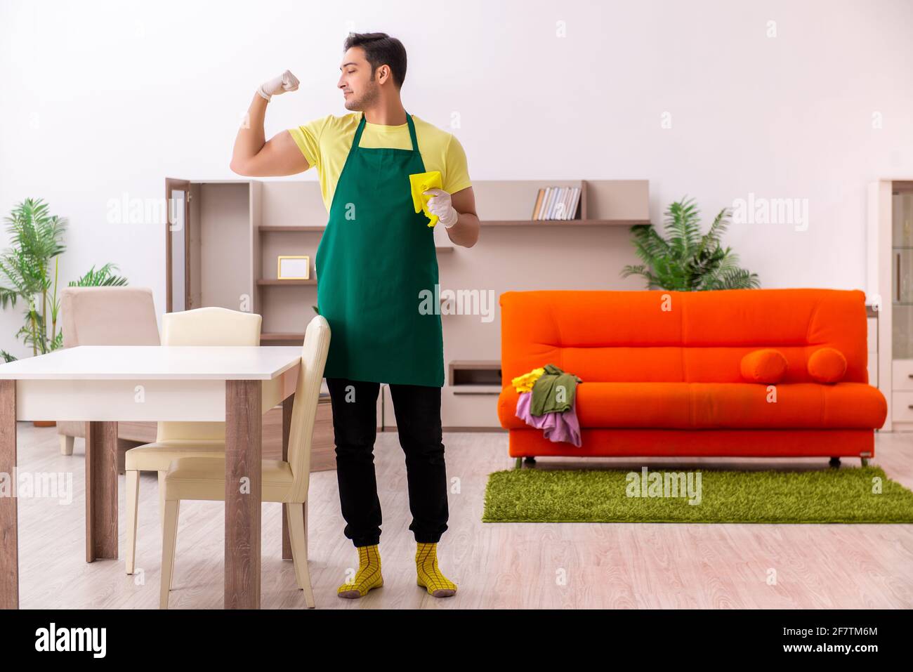 Young contractor cleaning the house indoors Stock Photo - Alamy
