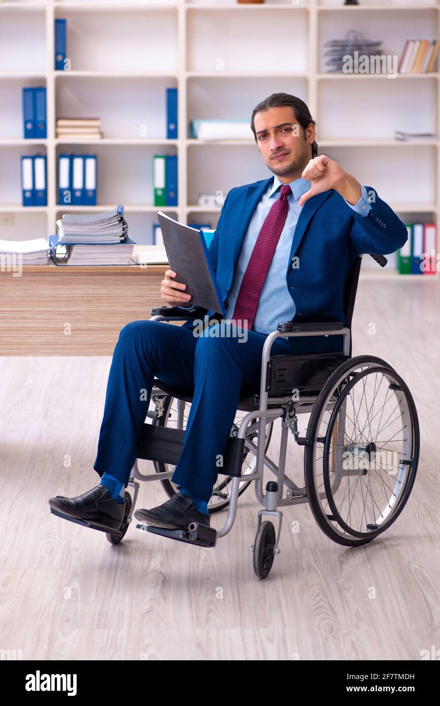 Young male disabled employee working in the office Stock Photo - Alamy