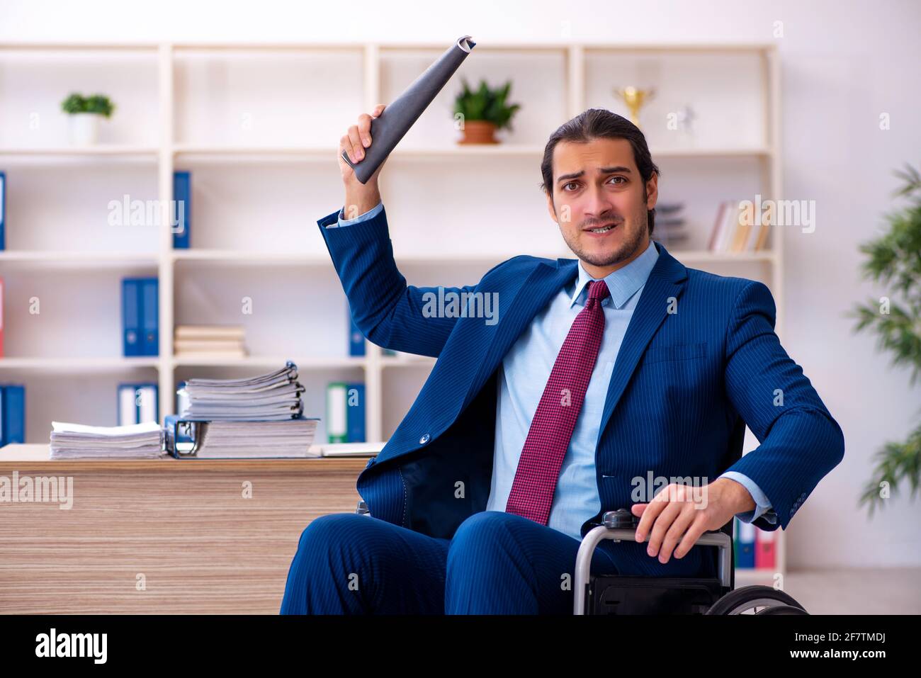 Young male disabled employee working in the office Stock Photo - Alamy