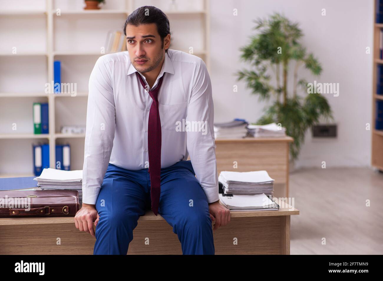Extremely tired businessman male employee in the office Stock Photo - Alamy