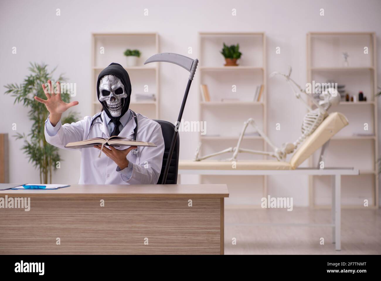 Reaper grim doctor examining skeleton patient in the clinic Stock Photo ...