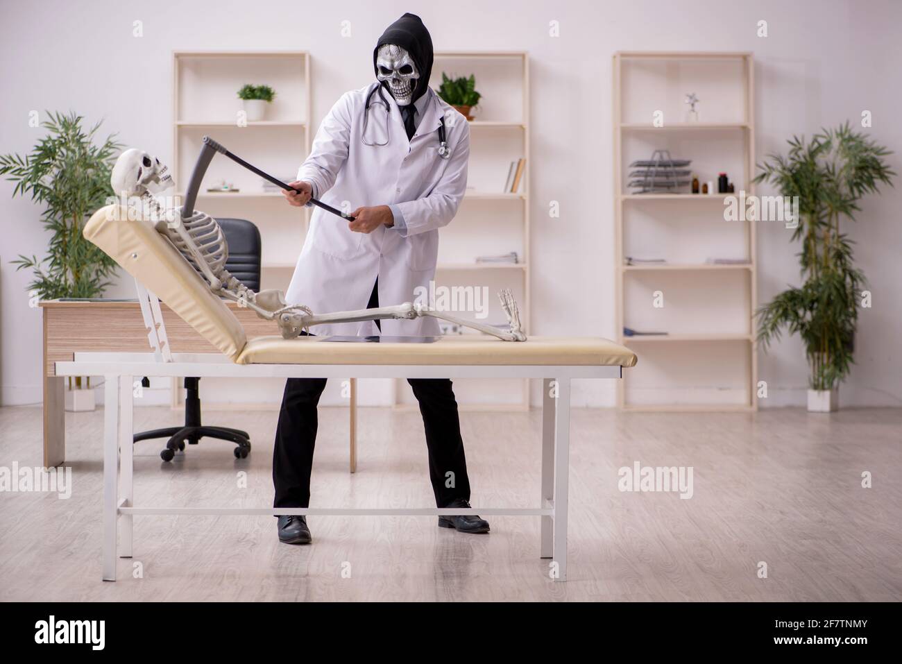 Reaper grim doctor examining skeleton patient in the clinic Stock Photo ...