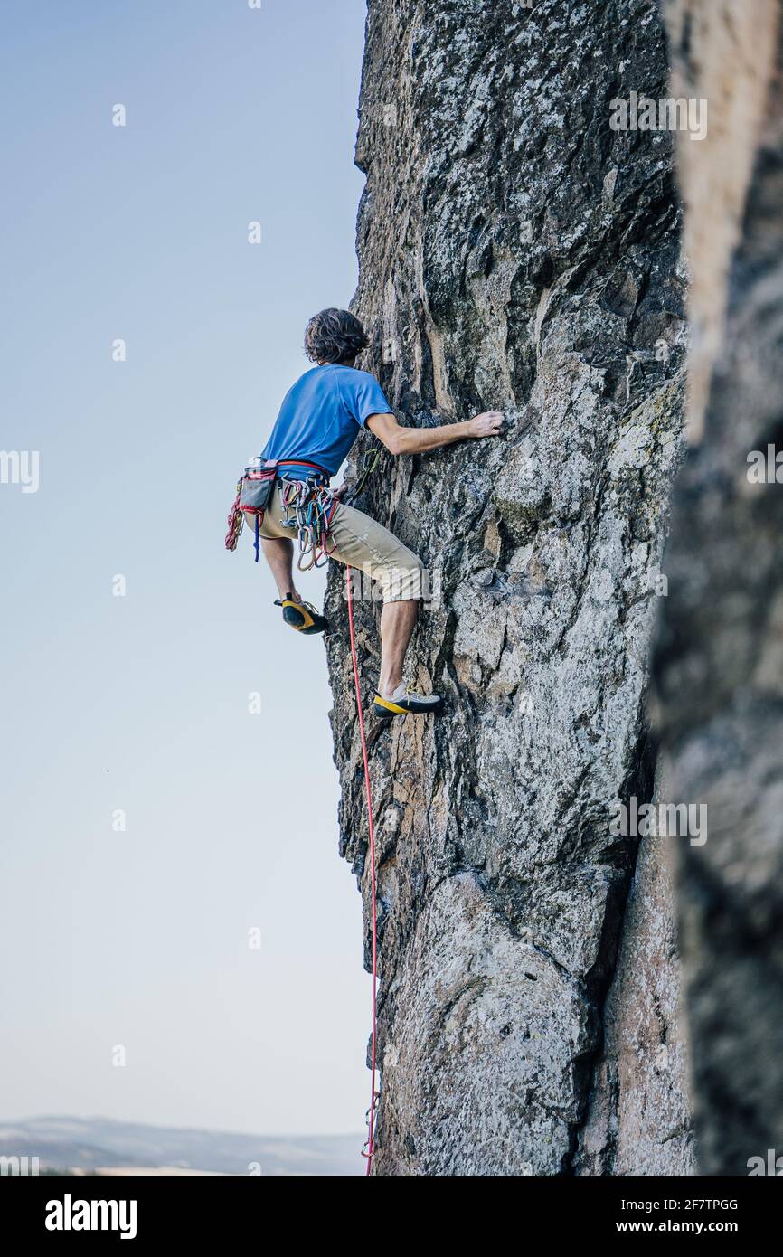 Climber ascending a steep rock Stock Photo - Alamy