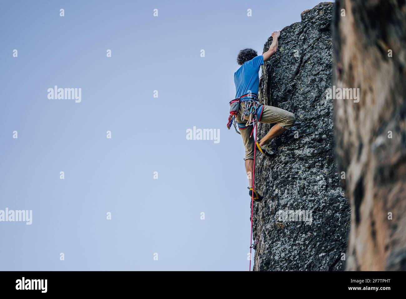 Climber ascending a steep rock Stock Photo - Alamy