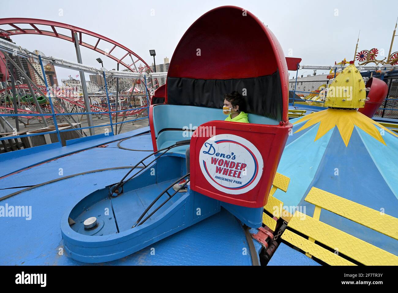 A young boy sits in a Tilt-a-Whirl ride at Deno’s Wonder Wheel ...