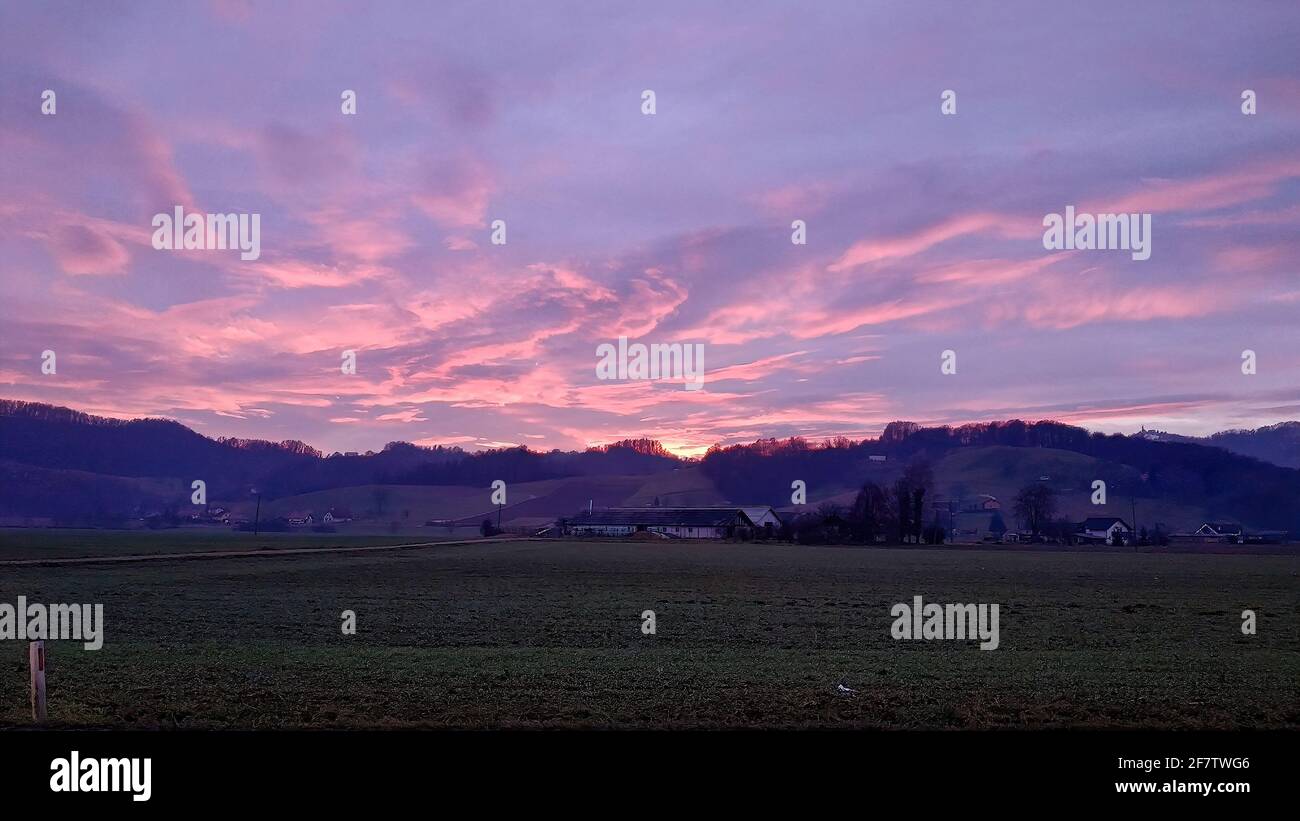 Scenic shot of a beautiful cloudscape across the mountains and fields ...