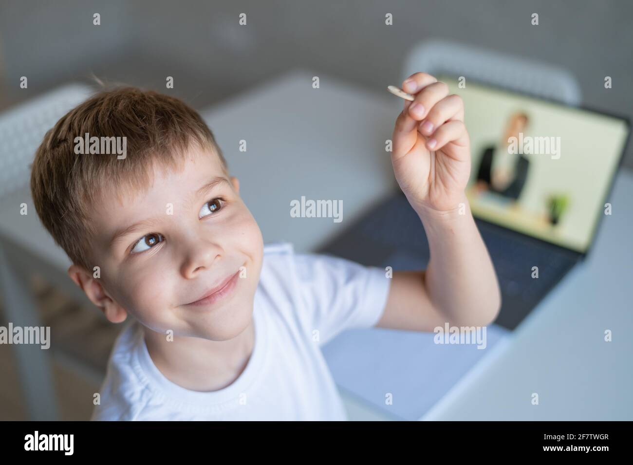 A boy learns the alphabet with a laptop teacher. Distance learning by ...