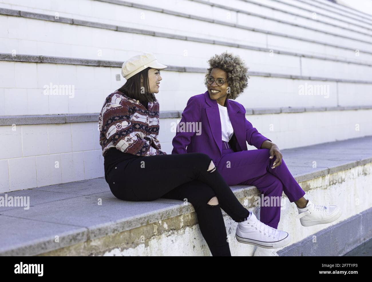 Multiracial friends sitting around and laughing - African American and ...
