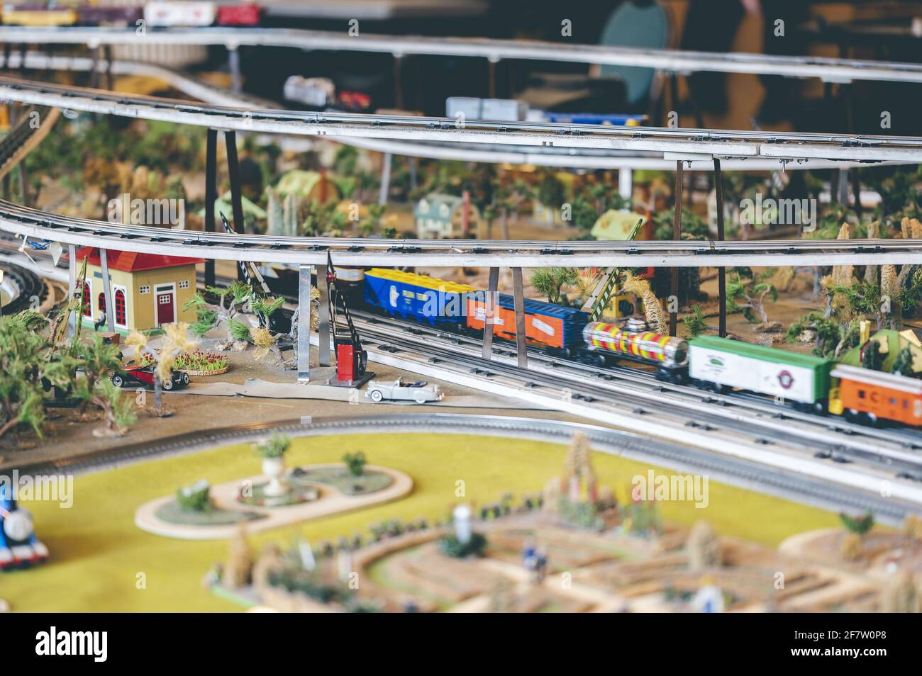 Closeup shot of a small city model with parks, trains, and bridges ...