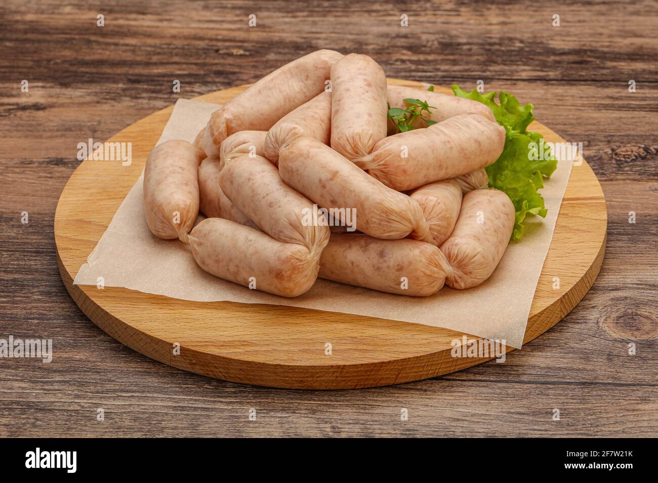 Raw natural chicken baby sausages for roast Stock Photo - Alamy