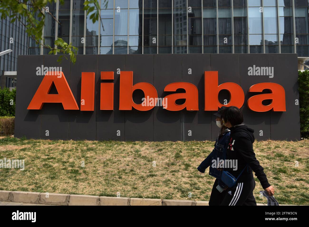 BEIJING, CHINA - APRIL 10, 2021 - A pedestrian walks past the Alibaba ...