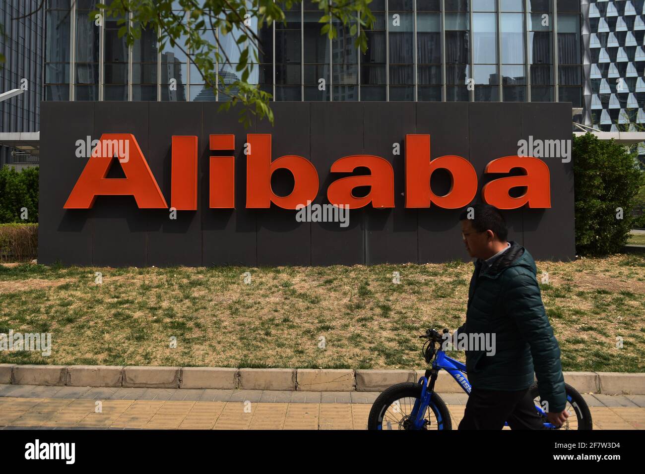 BEIJING, CHINA - APRIL 10, 2021 - A pedestrian walks past the Alibaba ...