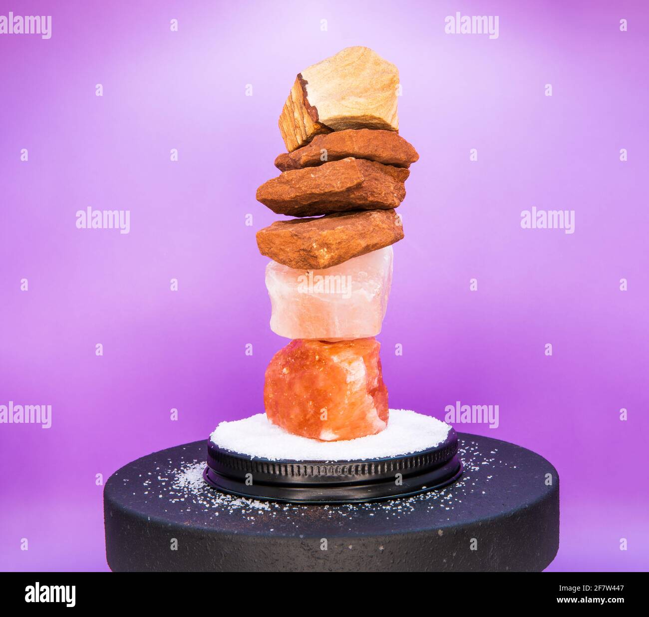 Large chunks of Himalayan sea salt and red sandstone are stacked on top ...